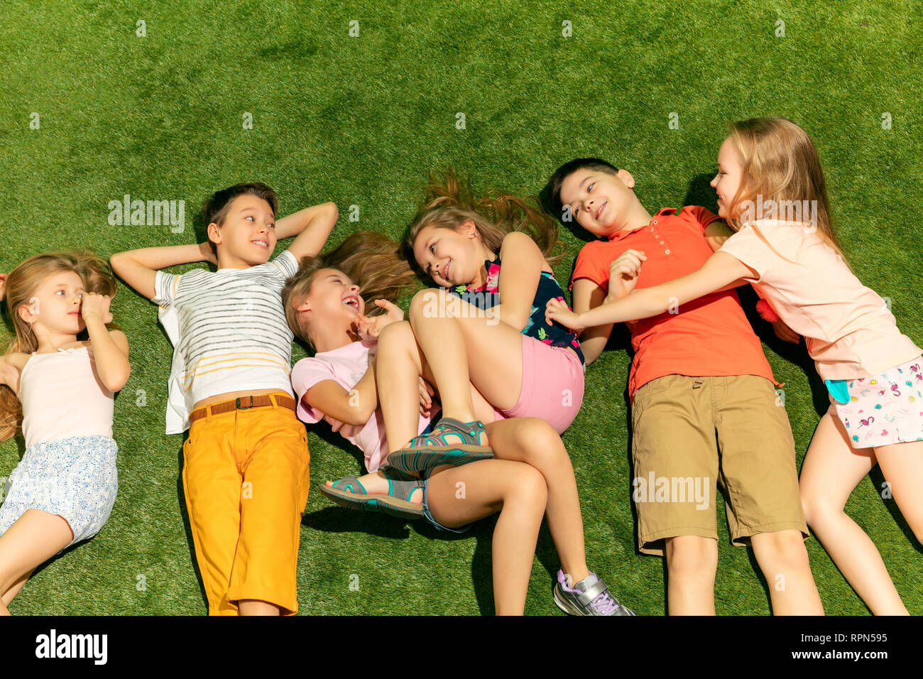 Group of happy children playing outdoors. Kids having fun in spring ...