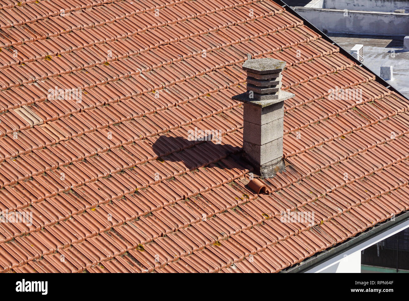 A close up view of a chimney on top of red roof tiles Stock Photo - Alamy