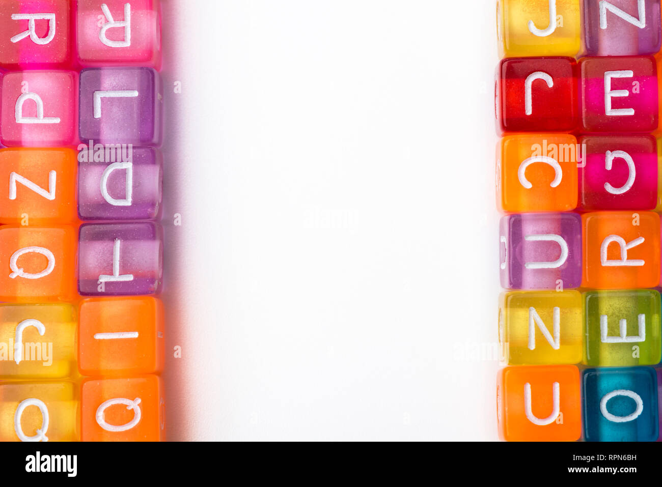Lots of colorful decorative cubes with letters on white background. The ...