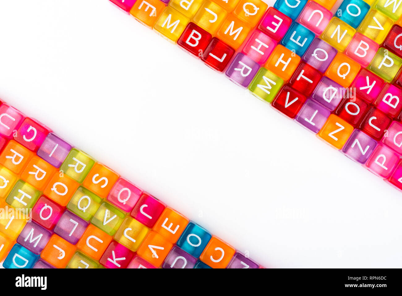 Lots of colorful decorative cubes with letters on white background. The ...