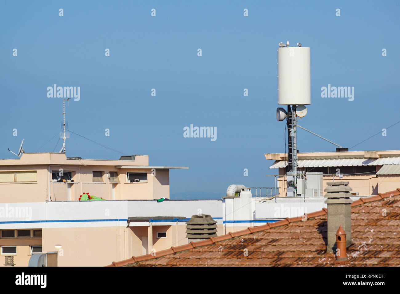 Mobile telephone radio network antennas on the building roof ...