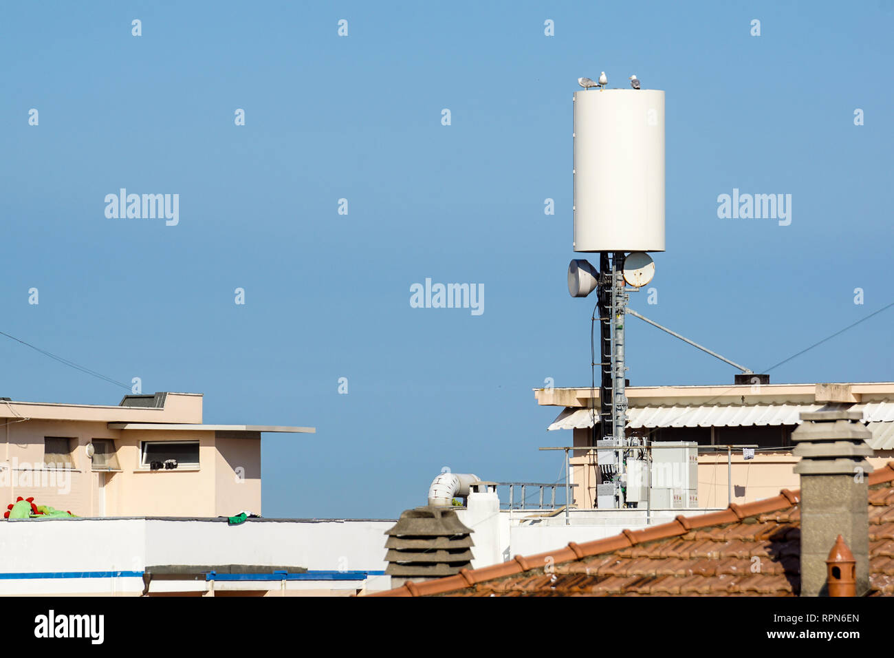 Mobile telephone radio network antennas on the building roof ...