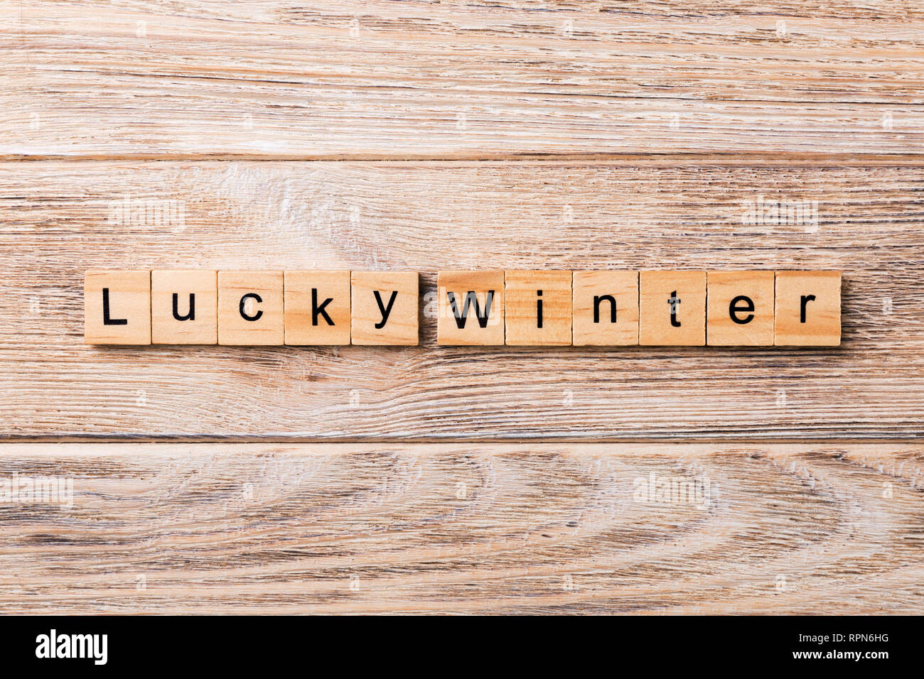 Lucky winter word written on wood block. Lucky winter text on wooden ...
