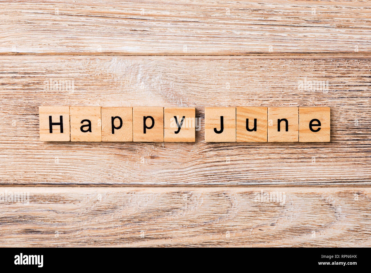 Happy June word written on wood block. Happy June text on table ...