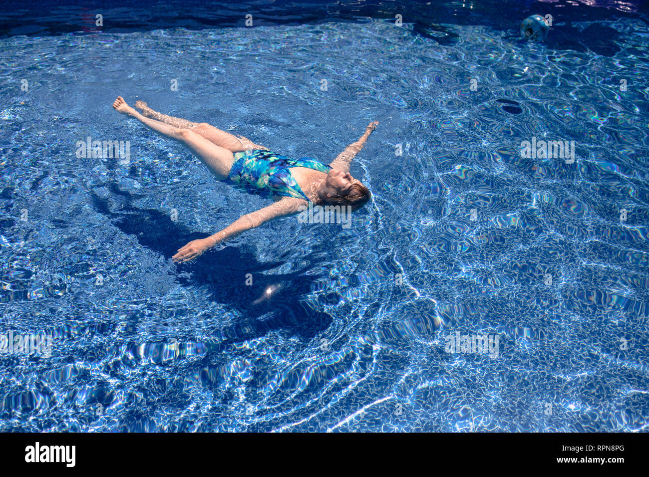 Senior woman floating in the swimming pool Stock Photo - Alamy