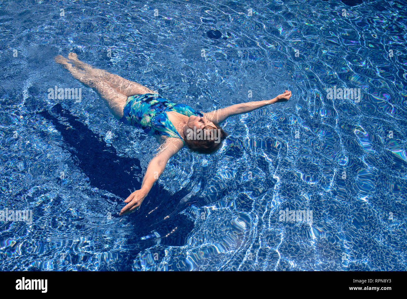 Senior woman floating in the swimming pool Stock Photo - Alamy