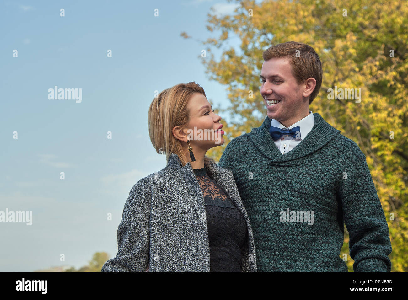 Romantic couple relaxing in autumn park, cuddling, kissing, enjoying ...