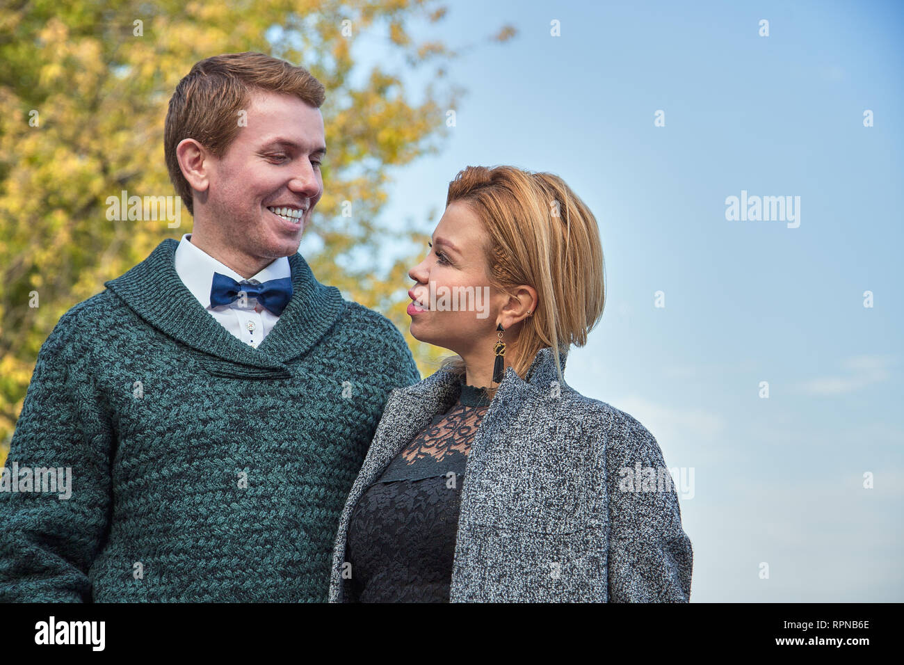 Romantic couple relaxing in autumn park, cuddling, kissing, enjoying ...