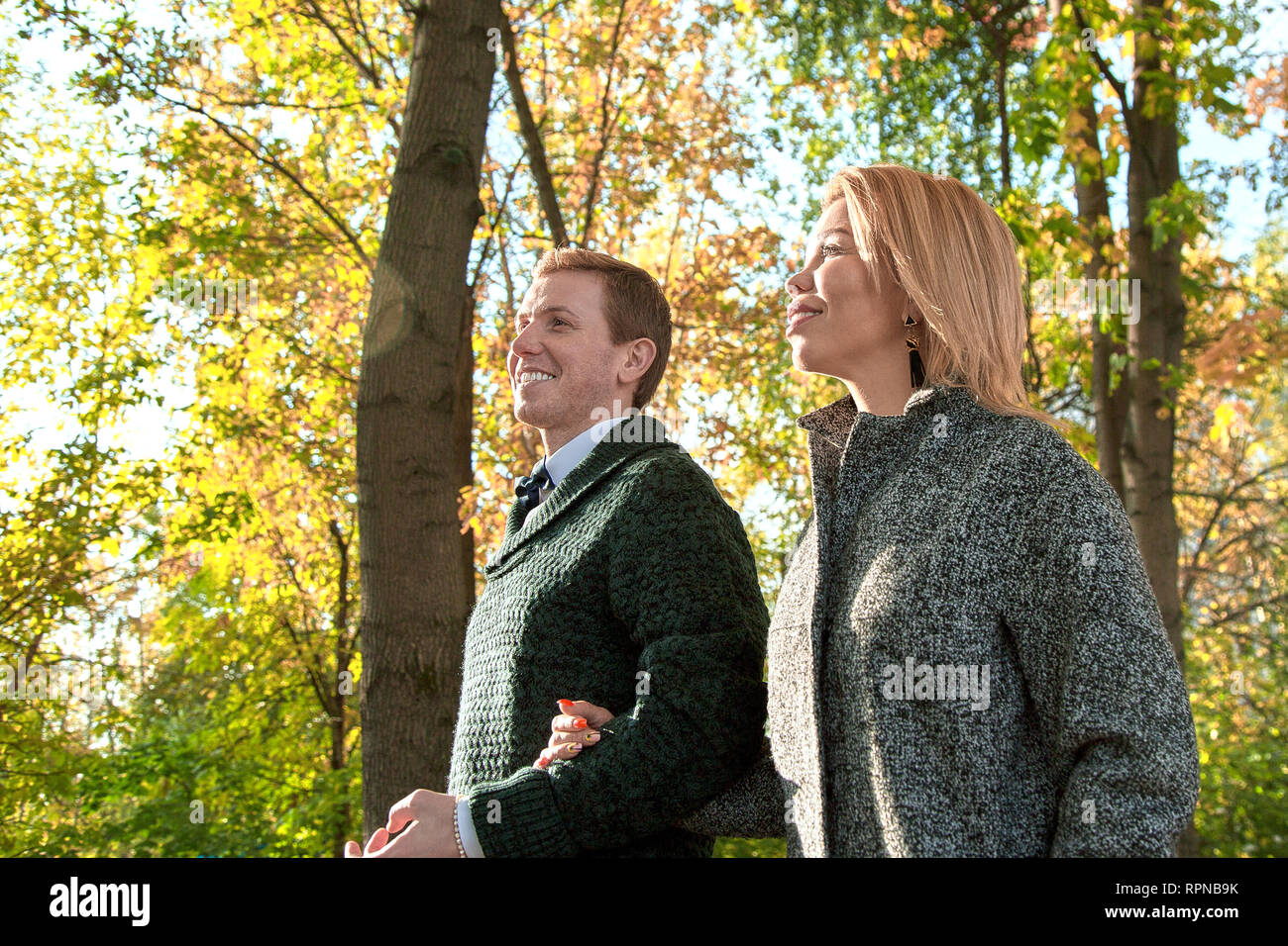 Romantic couple relaxing in autumn park, cuddling, kissing, enjoying ...