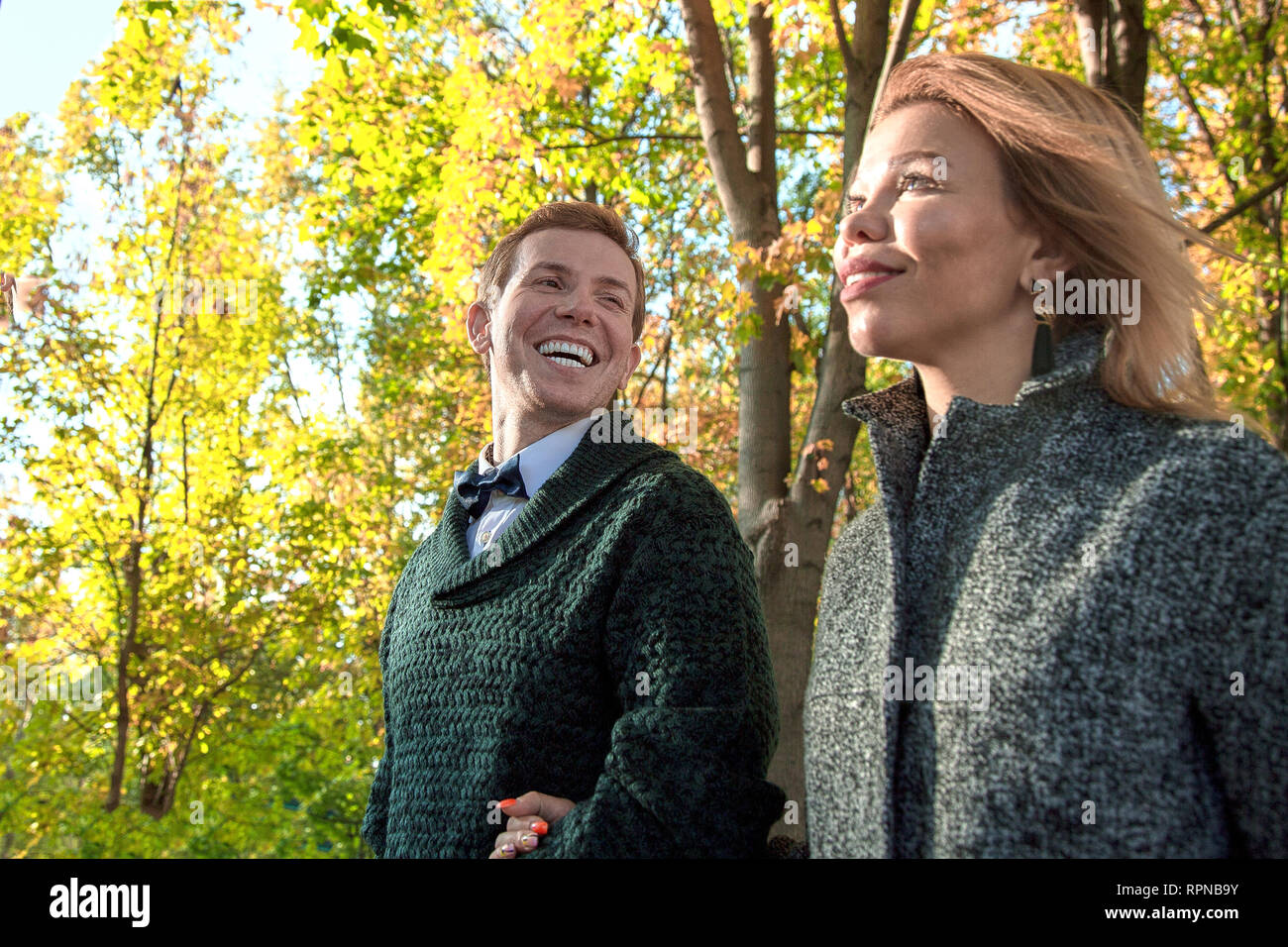 Romantic couple relaxing in autumn park, cuddling, kissing, enjoying ...
