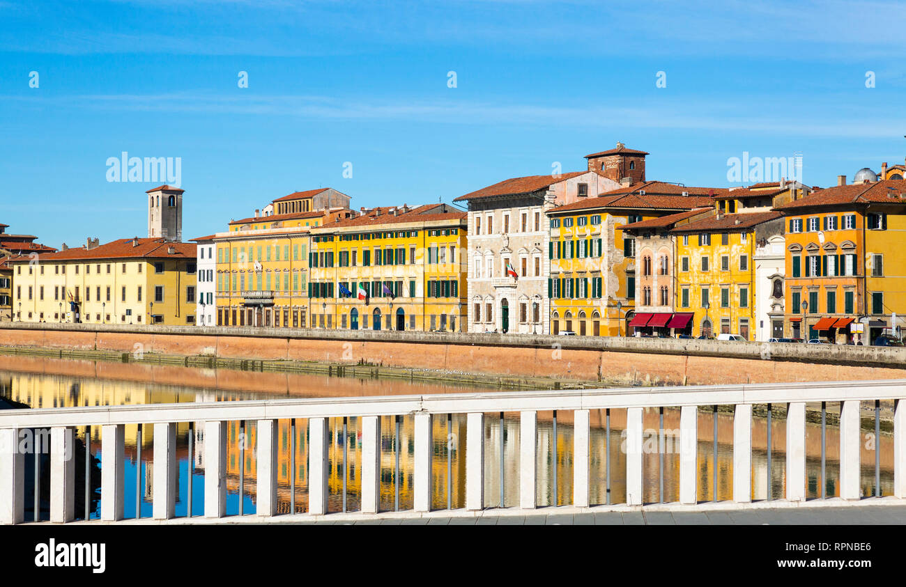 Pisa city centre in Italy with buildings reflected in the Arno River ...