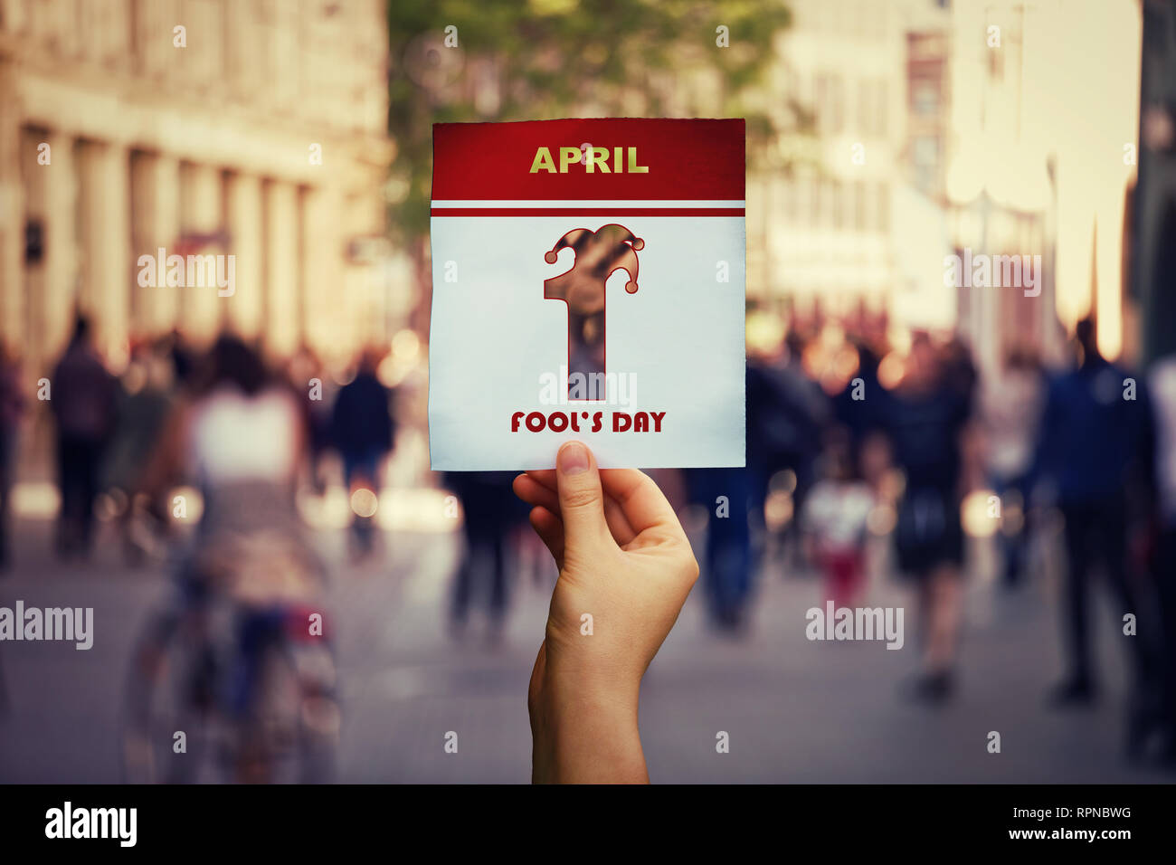 Hand holding a calendar page with 1 april fool's day symbol over ...