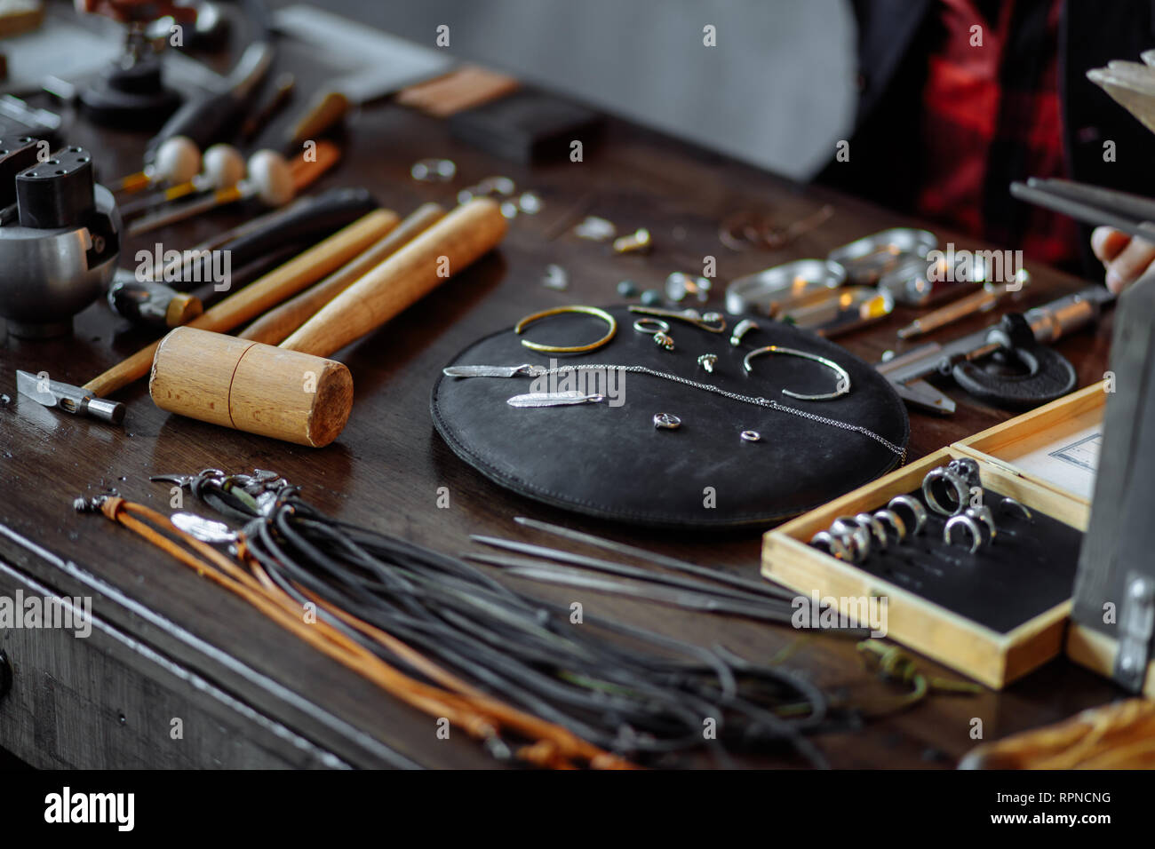 messy jeweler's table. useful tools for repairing materials, close up ...