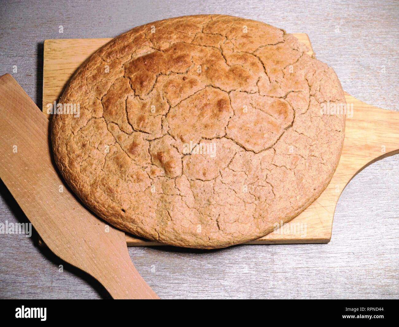 a healthy diet oats flat cake lies on the board, next to the scapula ...