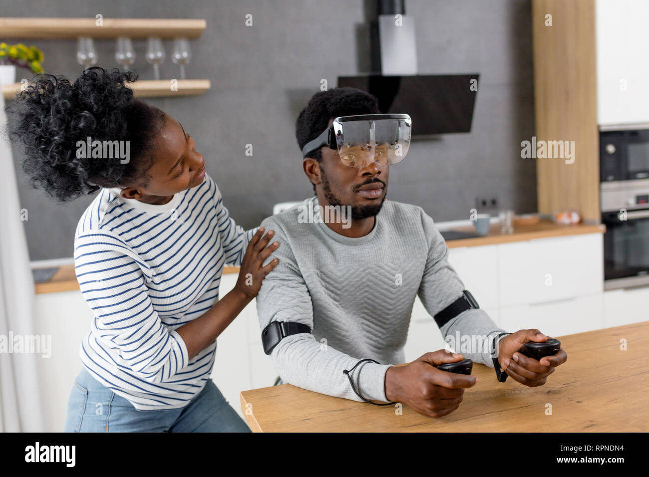Internet and game addiction concept. Loving african woman tries to ...