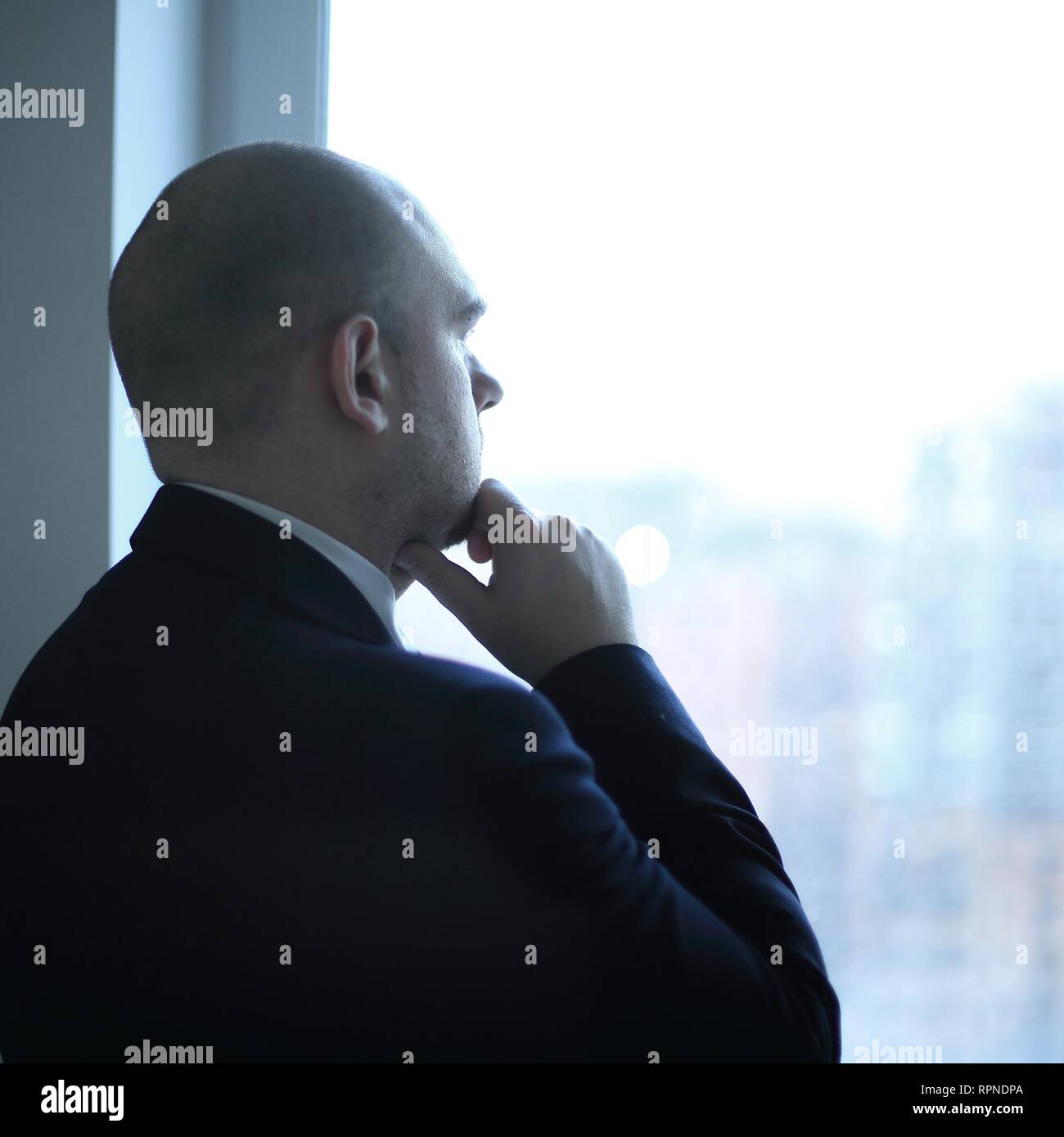 close up. thoughtful businessman looking in the office window Stock ...
