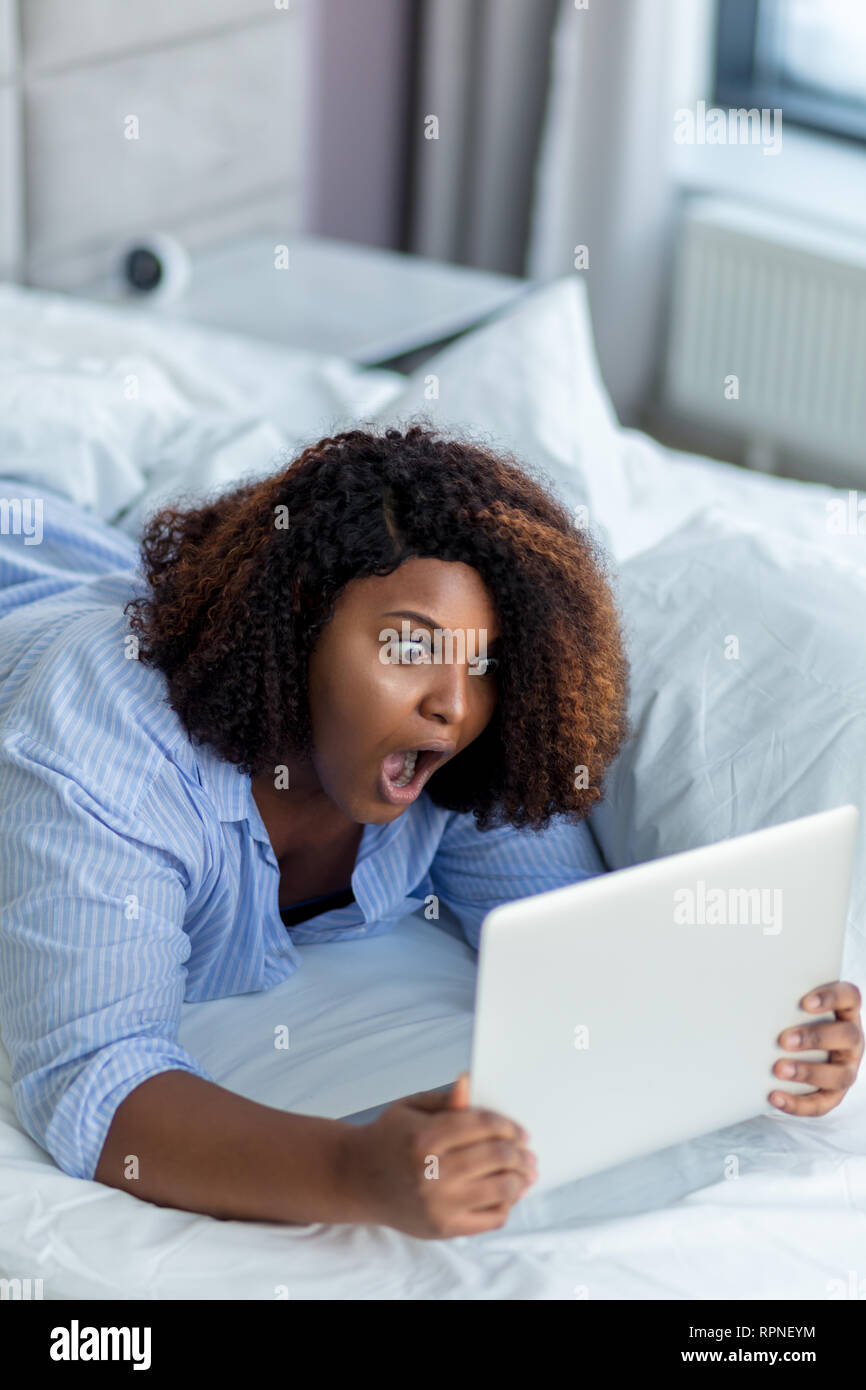 frustrated woman staring at the screen of the computer, surprised girl ...