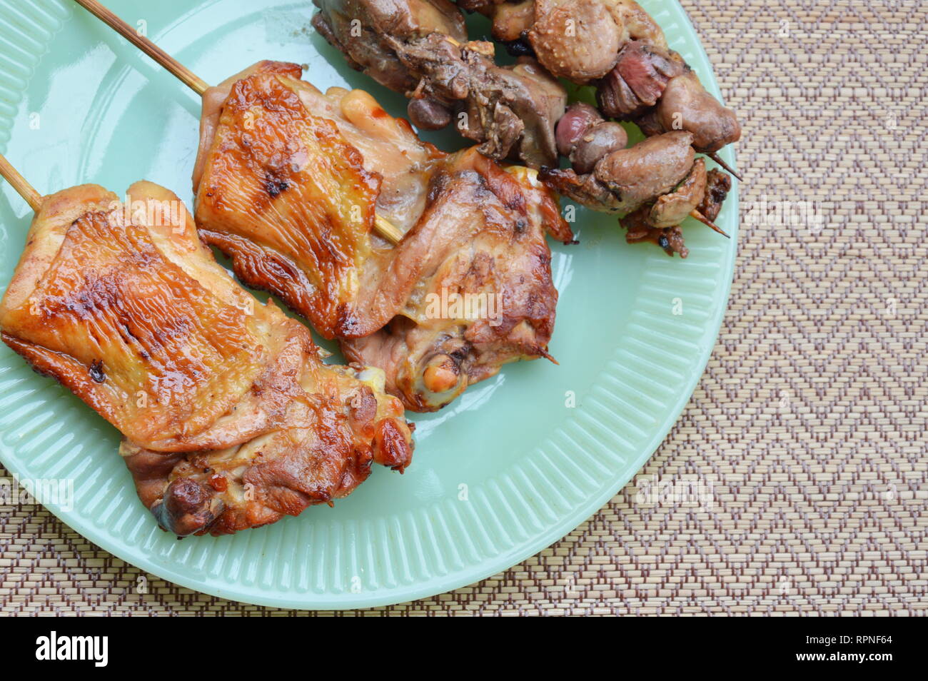 grilled chicken and entrails in wooden stick on dish Stock Photo - Alamy