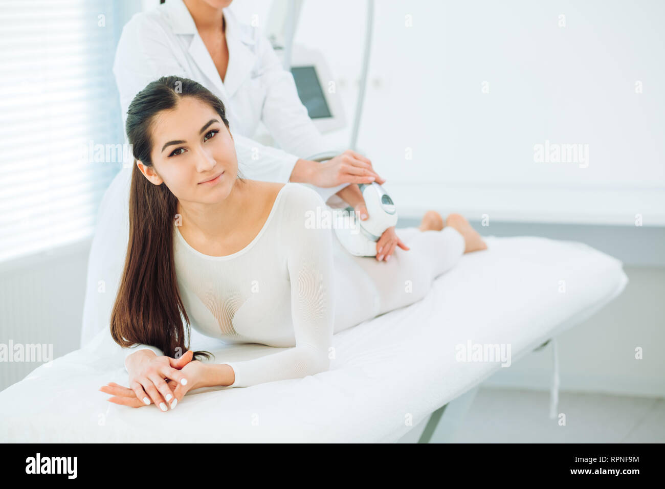 Portrait Of Brunette Woman Dressed In White Lpg Slimming Bodysuit