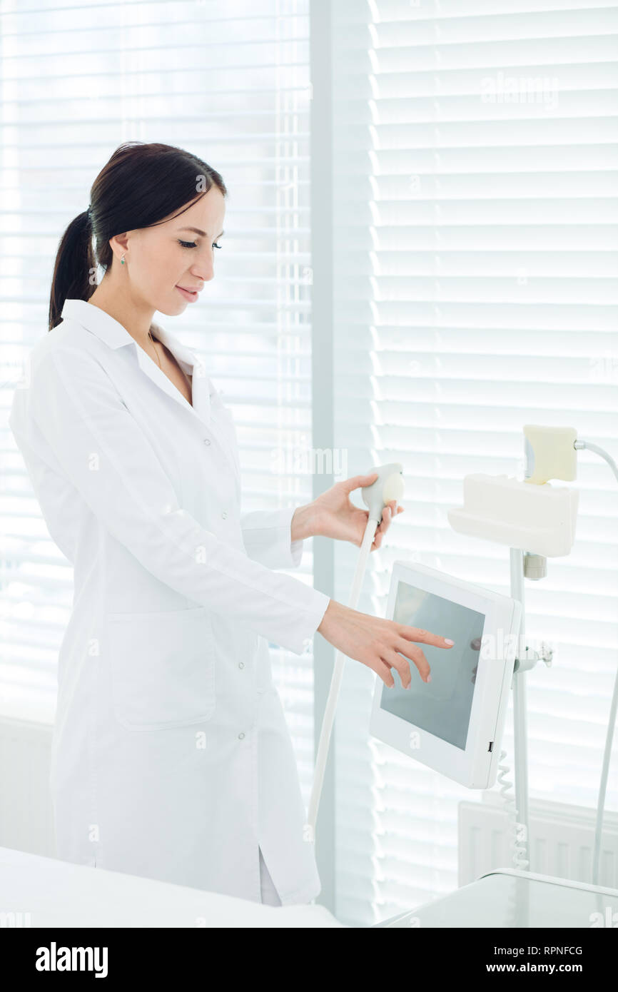 Young beautiful aesthetic medicine female doctor in white outfit ...