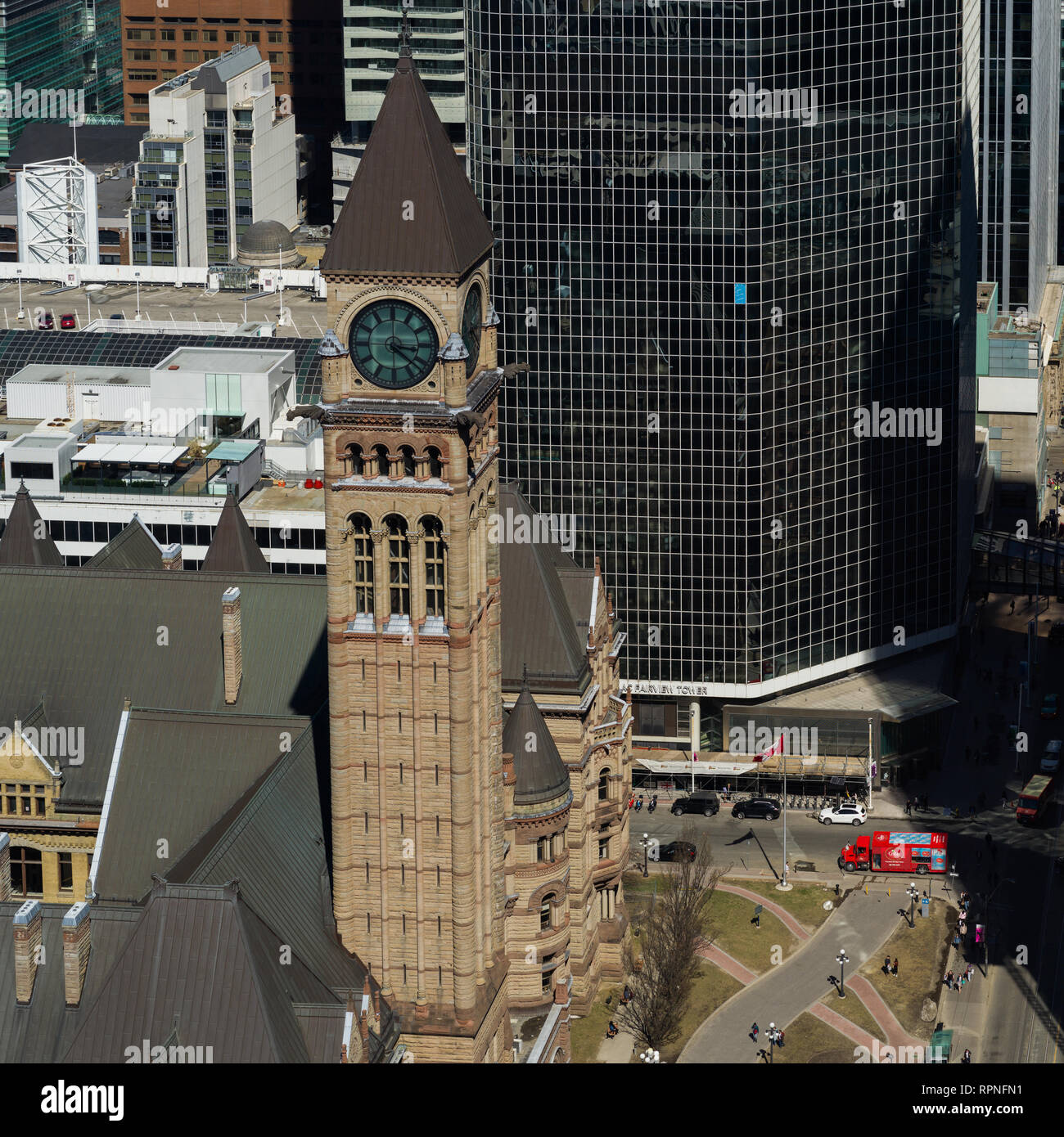 High angle view of clock tower of Old City Hall with modern buildings ...
