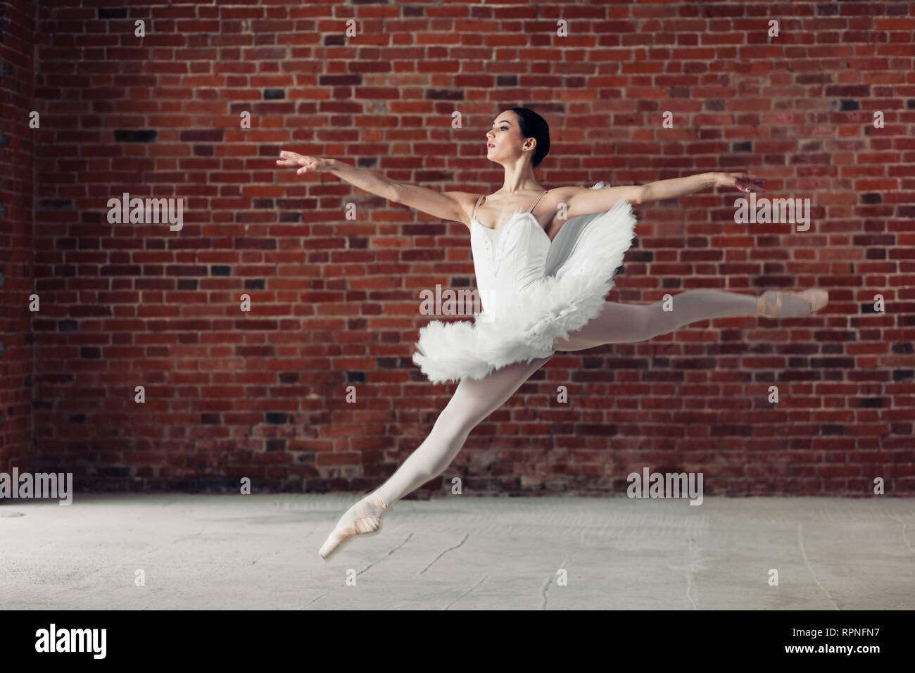 attractive ballerina making a jump, full length photo.strong emotion ...
