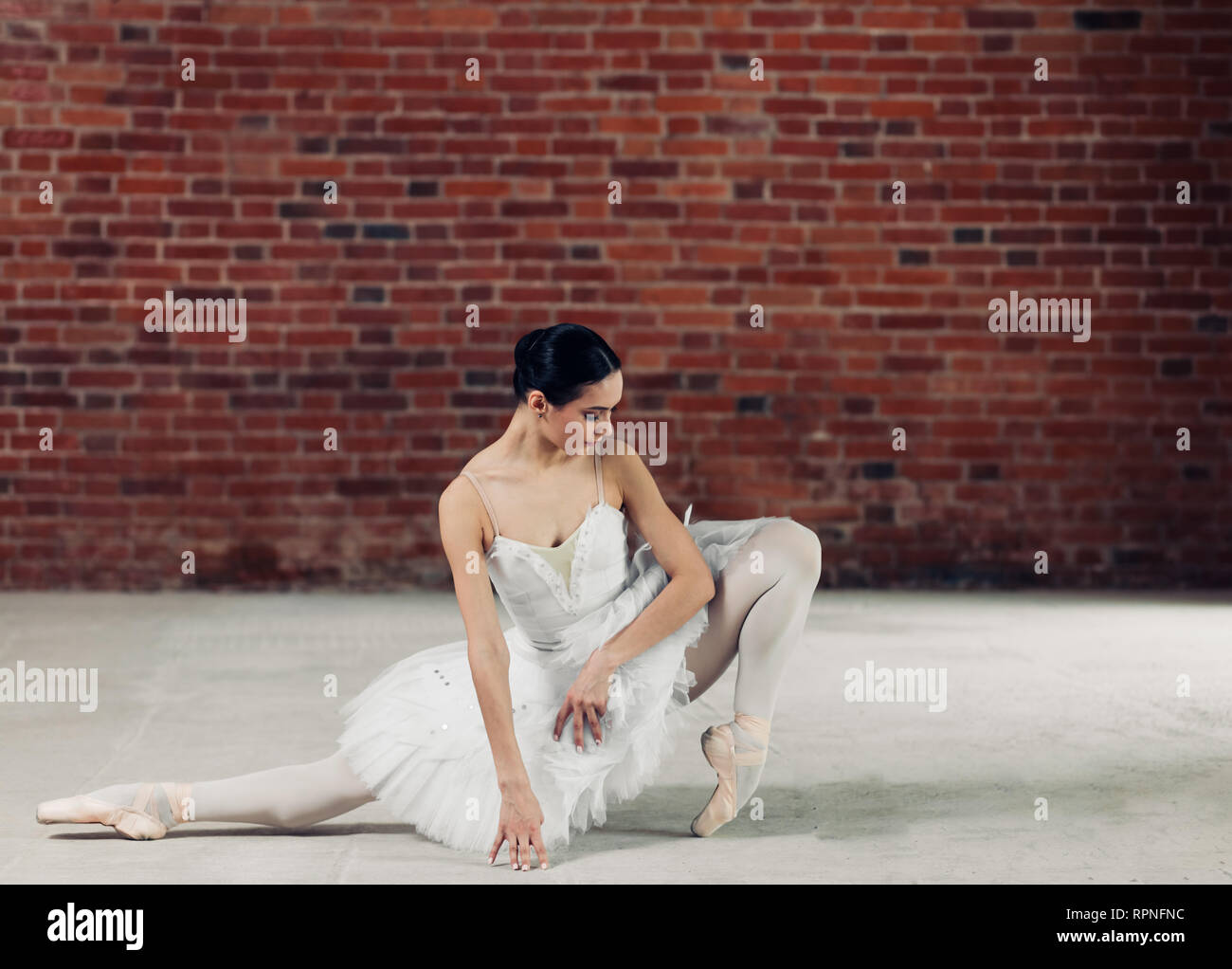 Young awesome talented motivated girl stretching on the floor . active ...