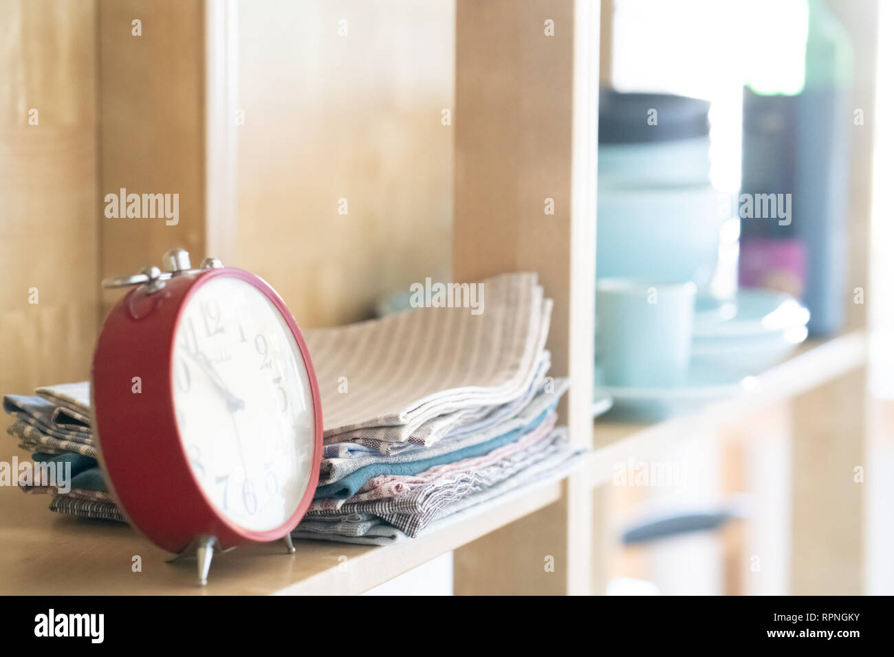 Vintage alarm clock on the shelf with dishes Stock Photo - Alamy
