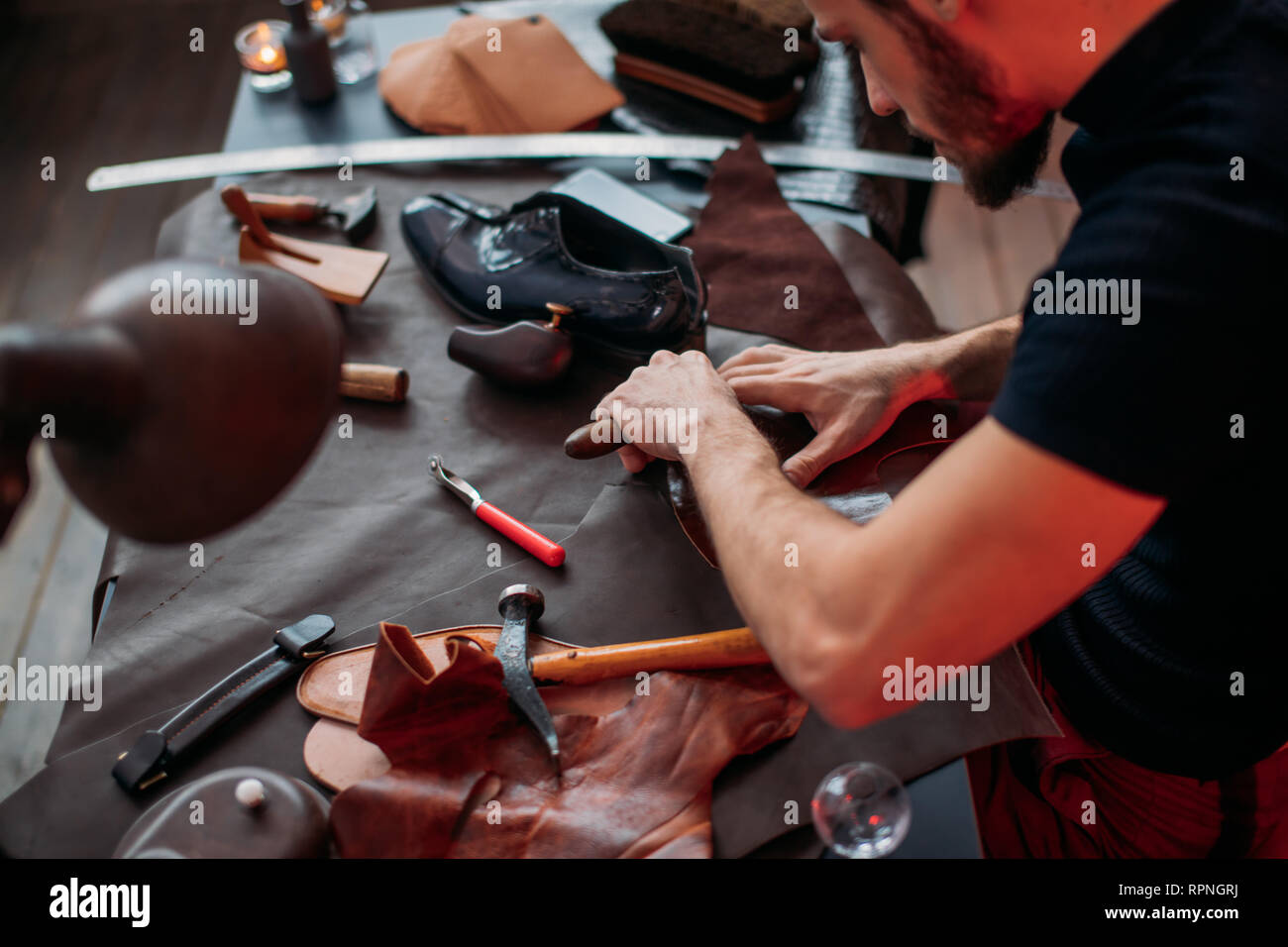 difficult work of a shoemaker, the trade of shoemaker, close up cropped ...
