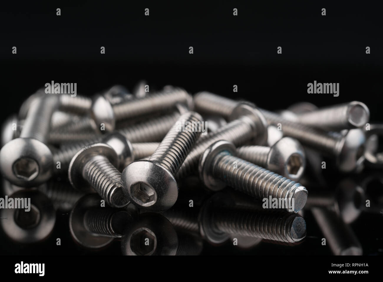 Screw and bolts on black background Stock Photo - Alamy