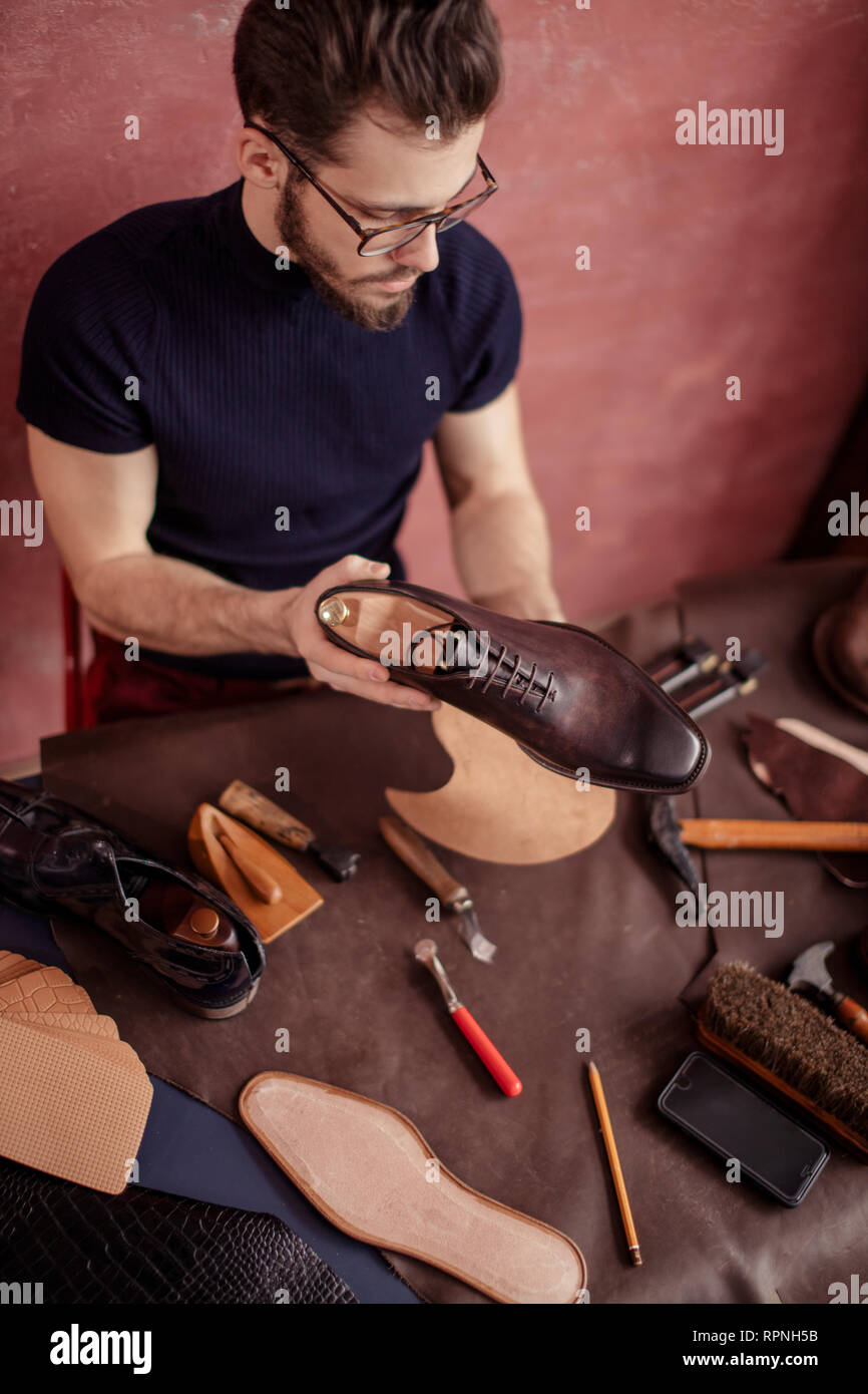 man specializing in creating shoes and boots. close up photo Stock ...
