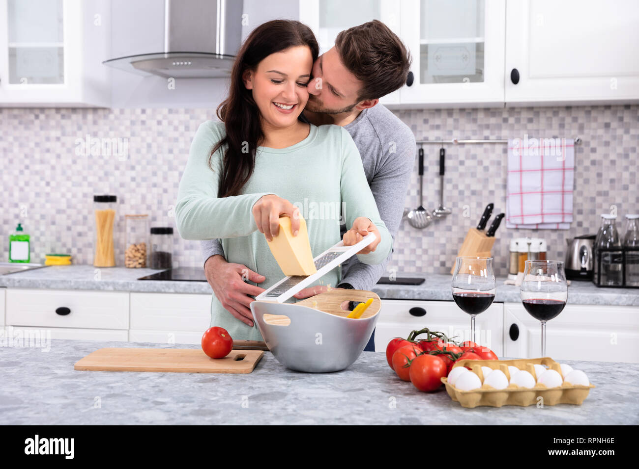 Couple kissing in kitchen hi-res stock photography and images - Alamy