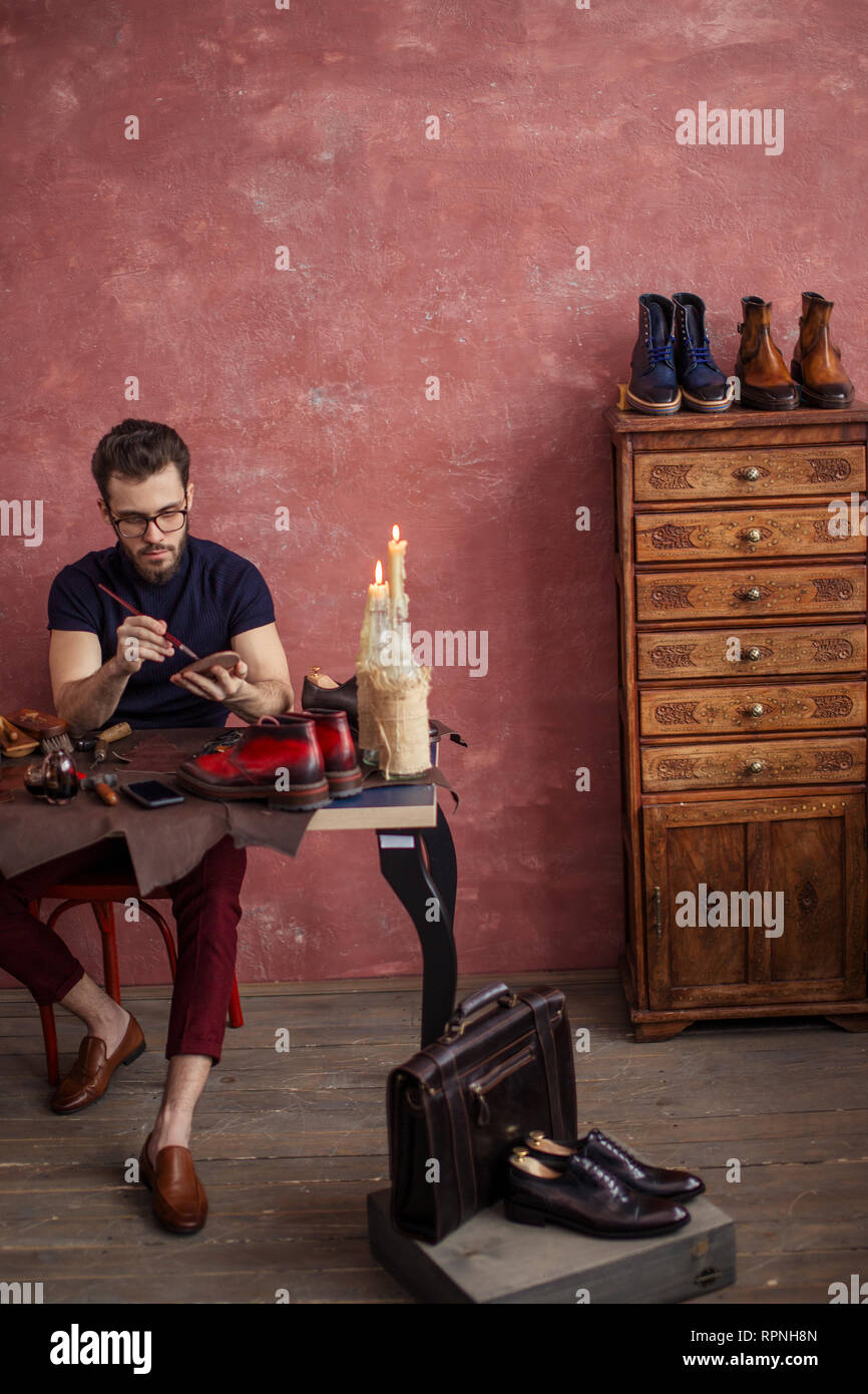 attractive designer changing the color of shoes, creative work. full ...