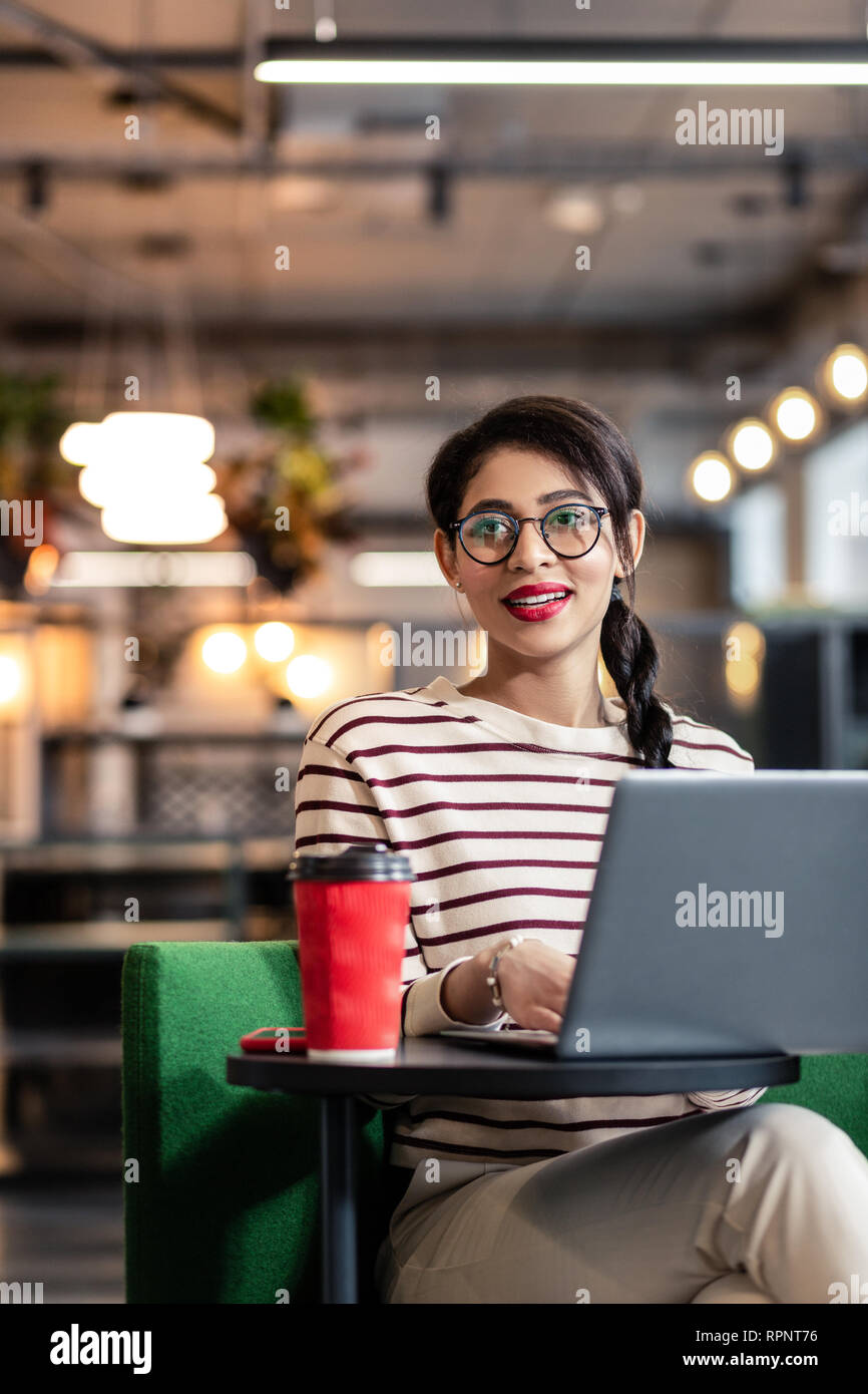 Positive delighted young female being deep in thoughts Stock Photo - Alamy