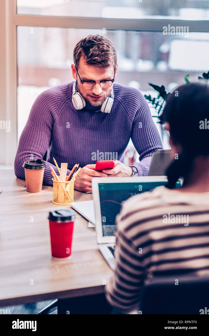 Serious male person staring at his gadget Stock Photo - Alamy