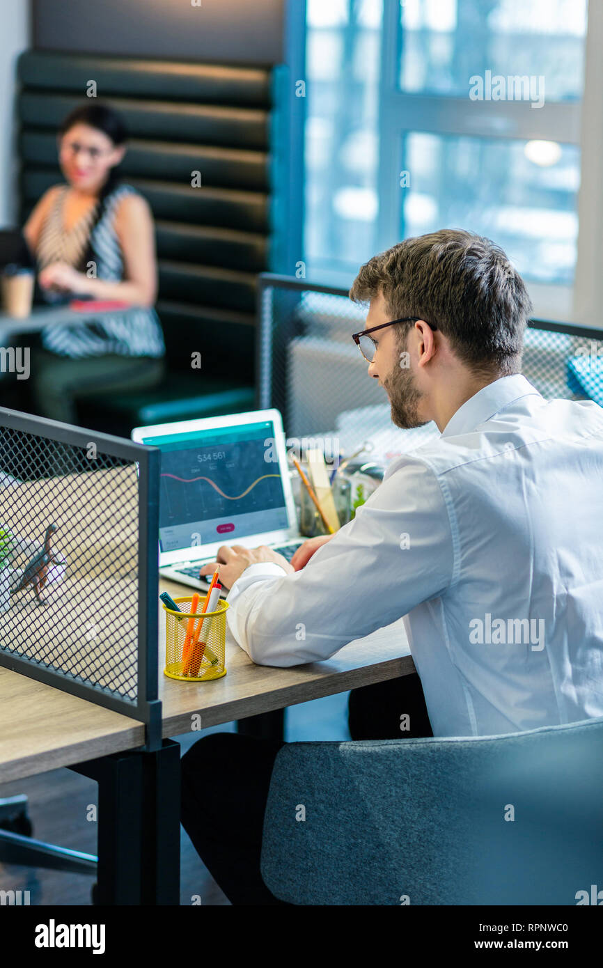 Handsome young man looking at screen of computer Stock Photo - Alamy