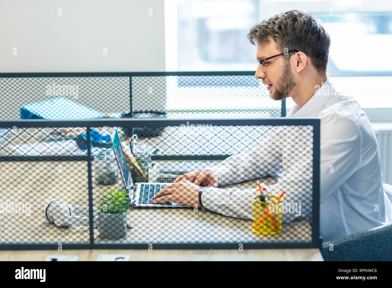 Attentive bearded man staring at screen of his laptop Stock Photo - Alamy
