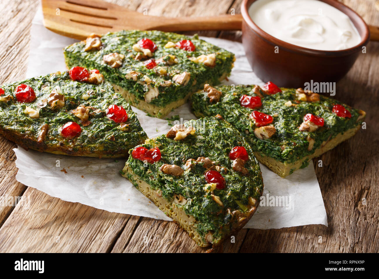 Middle Eastern omelette of herbs, eggs and nuts and dried berries close ...