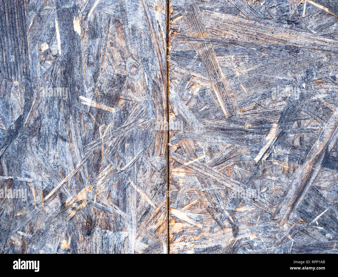 OSB boards are made of brown wood chips sanded into a wooden background ...