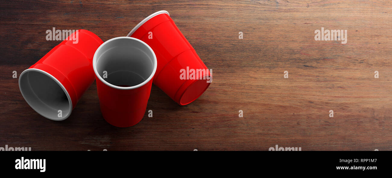 Plastic red color cups, disposable on wooden background, banner, copy ...