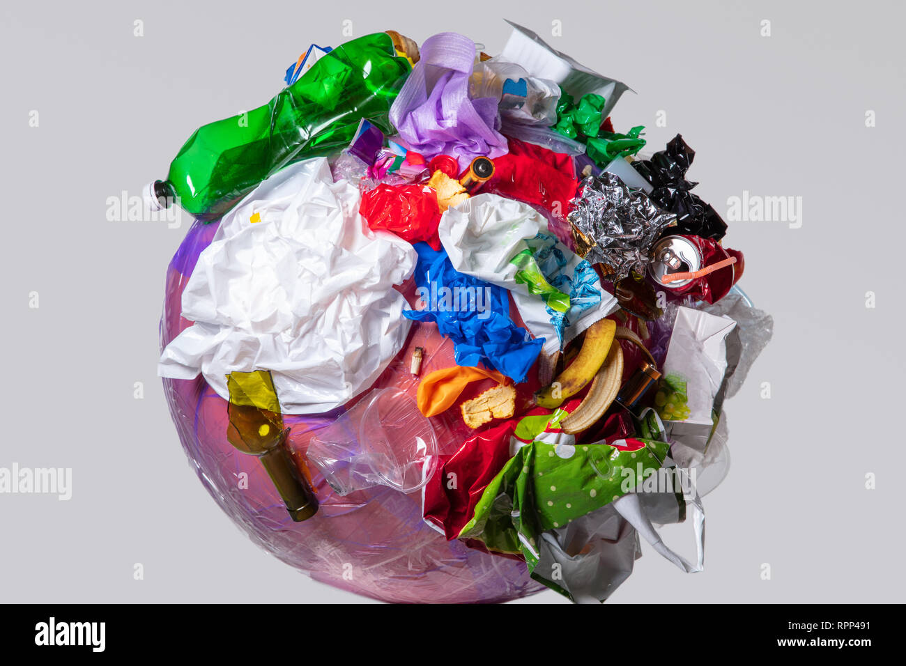 A globe of the earth with trash over white background, the concept of ...