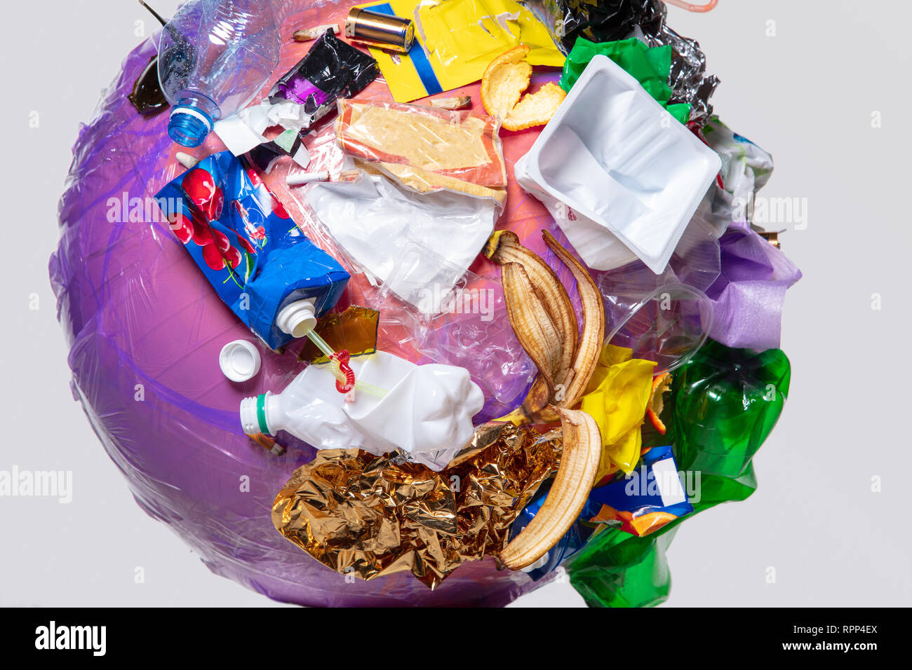 A globe of the earth with trash over white background, the concept of ...