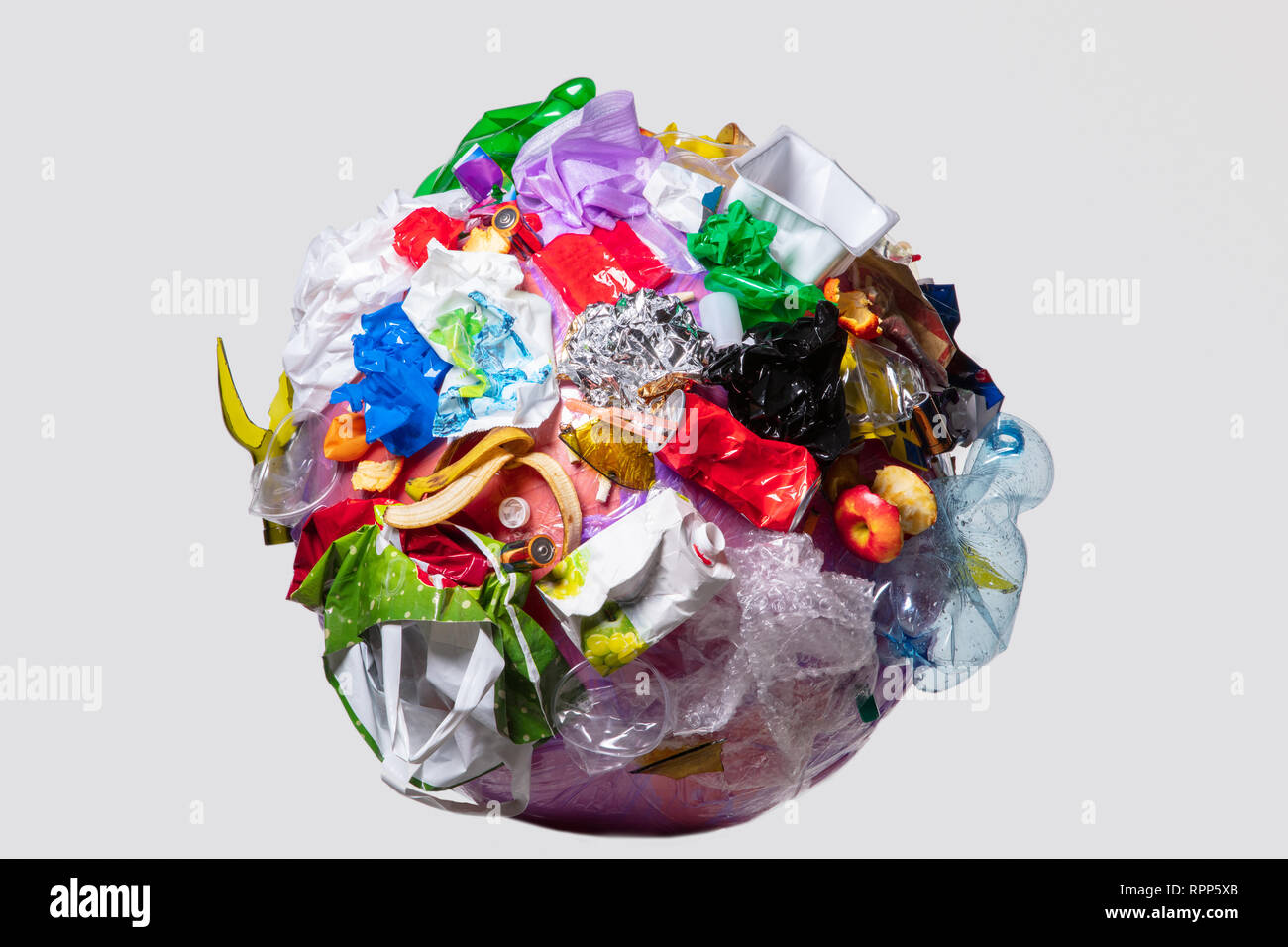 A globe of the earth with trash over white background, the concept of ...