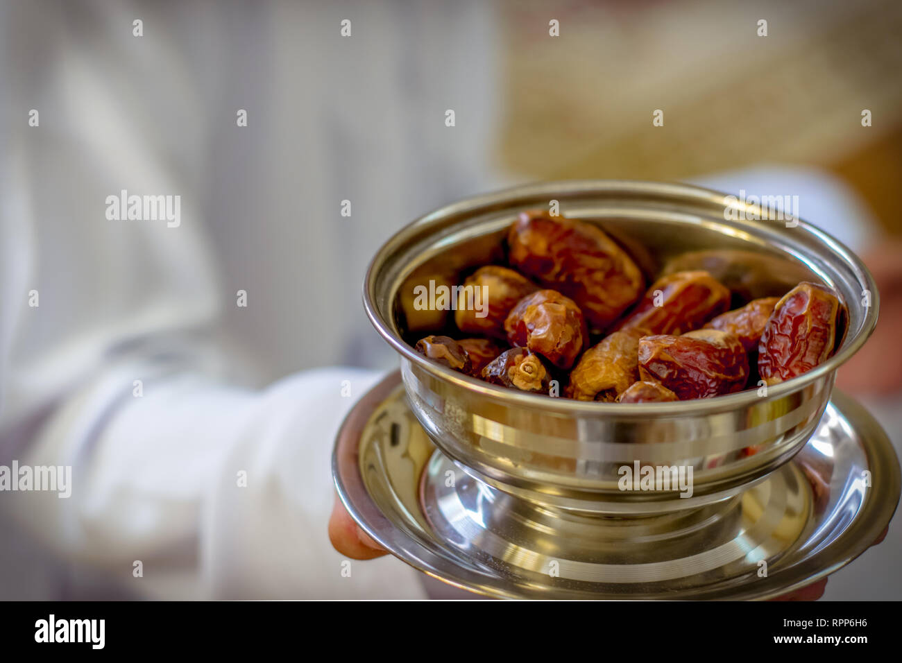 Hand serving dates Consept Stock Photo - Alamy