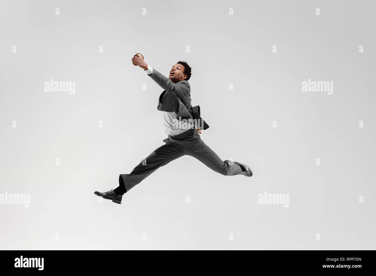 Happy businessman dancing in motion isolated on white studio background ...