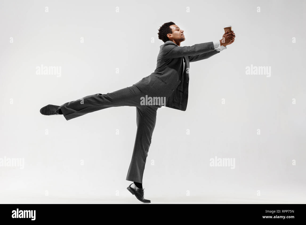 Happy businessman dancing in motion isolated on white studio background ...