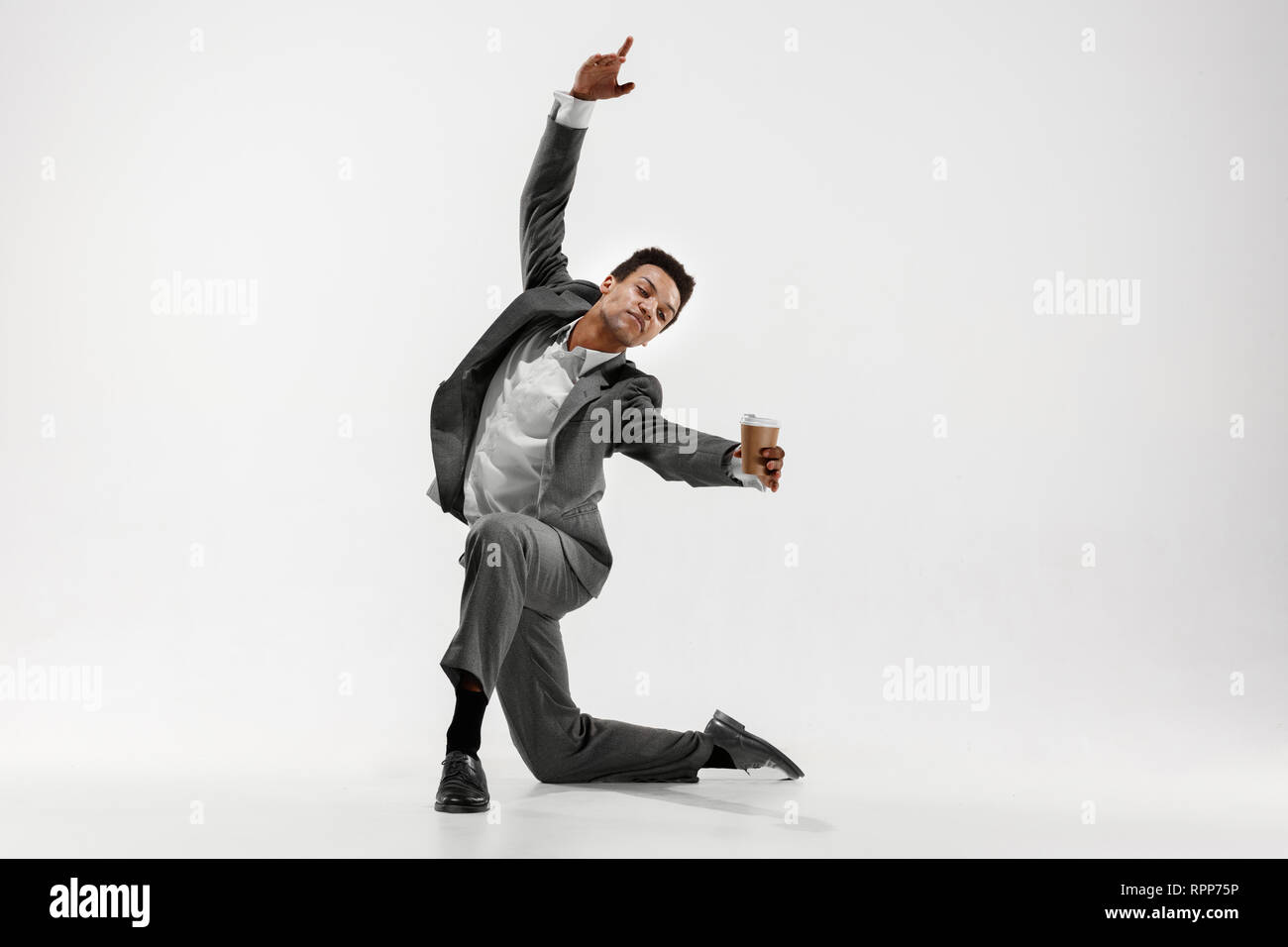 Happy businessman dancing in motion isolated on white studio background ...