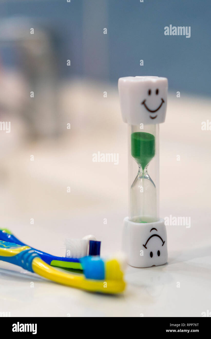 Concept of recommended time to brush your teeth. Soft focus. Two ...