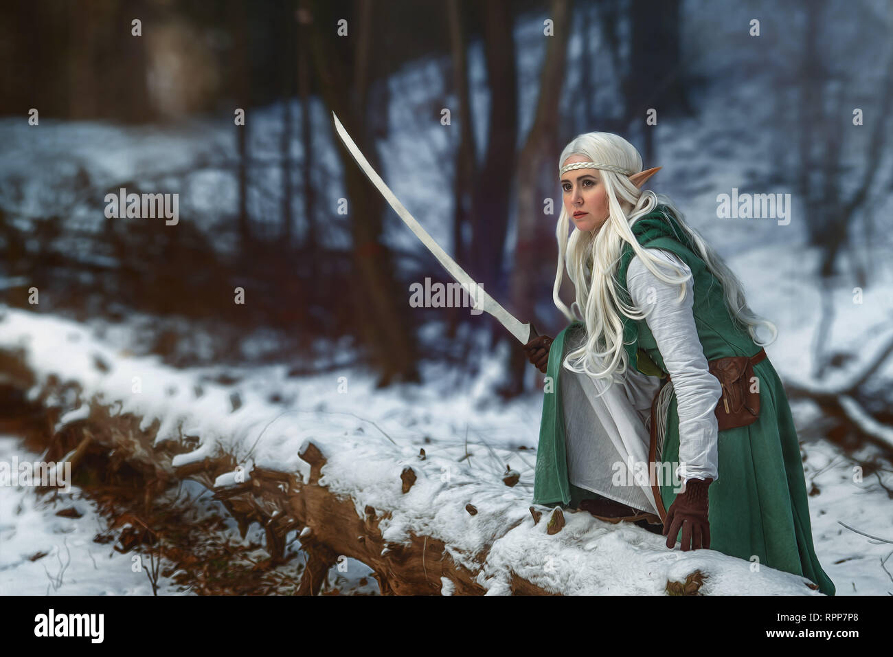 girl with a sword in her hand in an elf costume Stock Photo - Alamy