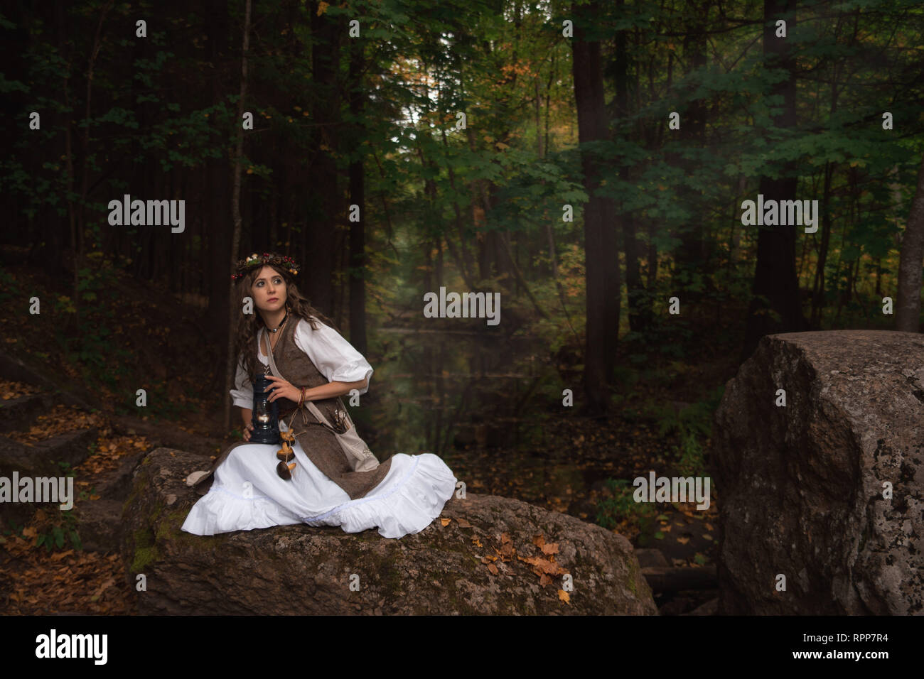 Young witch in autumn forest hi-res stock photography and images - Alamy